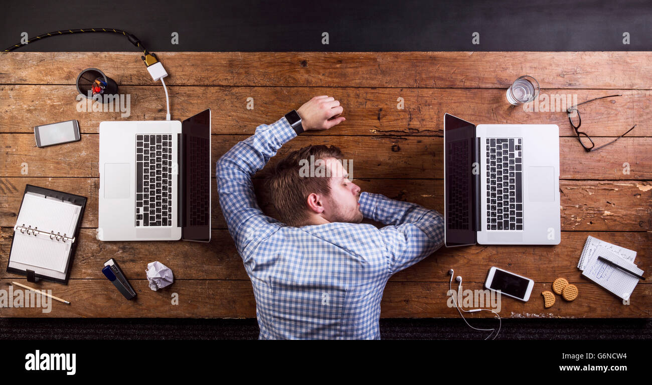 Young man sleeping at work, power napping Stock Photo - Alamy