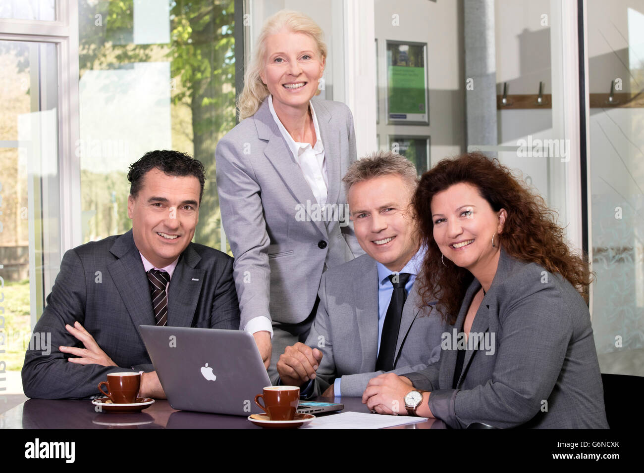 Confident and successful business people brainstorming ideas in a large ...