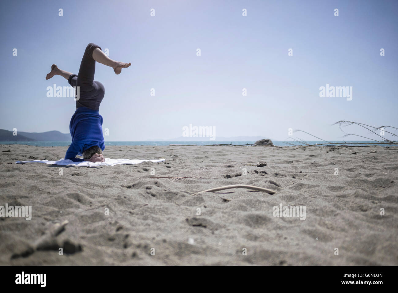 Woman doing headstand on beach hi-res stock photography and images - Alamy