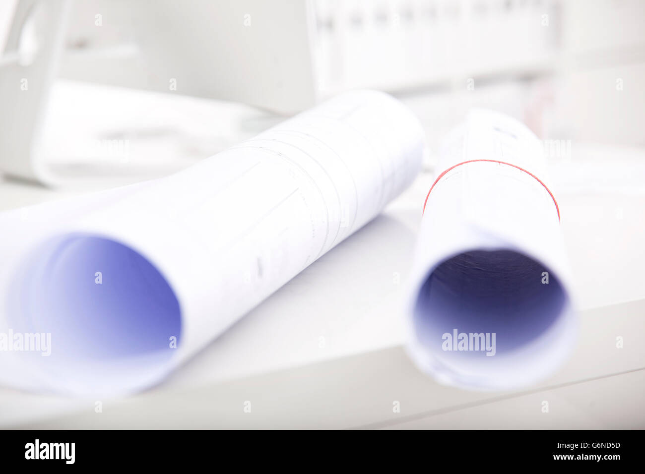 Rolled construction plans in an architecture office Stock Photo - Alamy