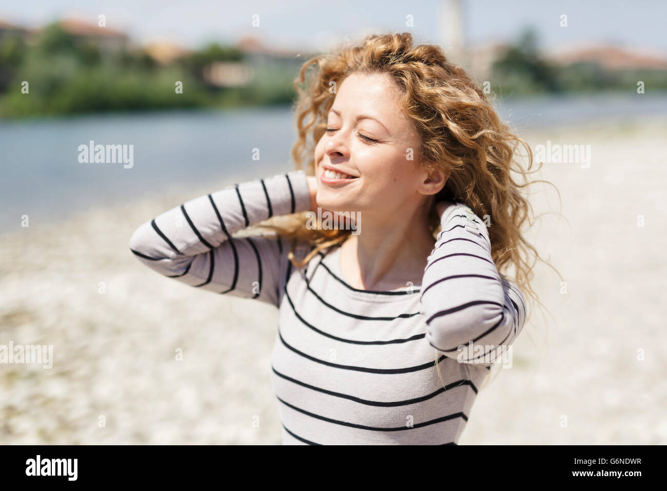 Portrait of woman enjoying sunlight Stock Photo - Alamy