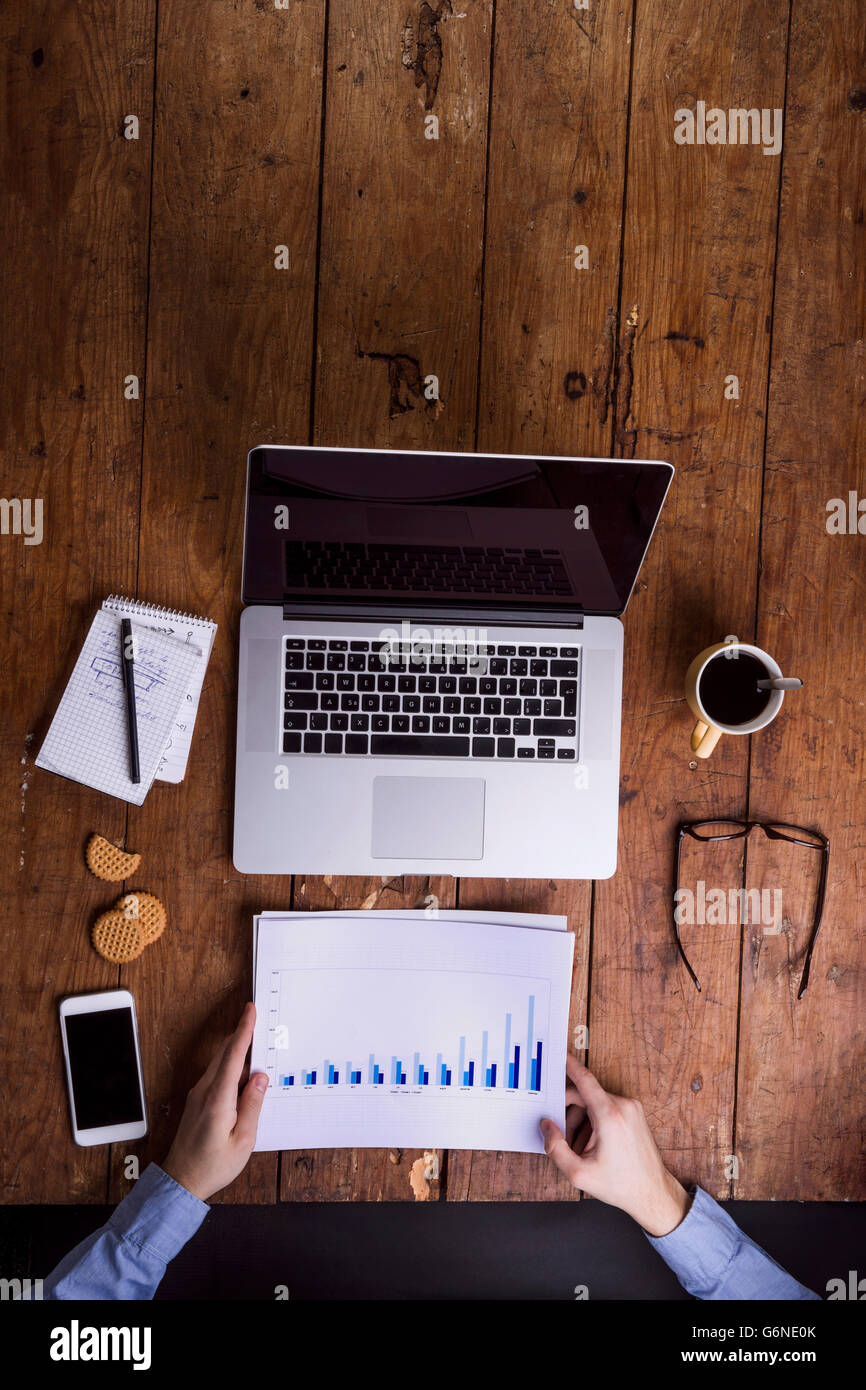 Man with charts at his desk Stock Photo - Alamy
