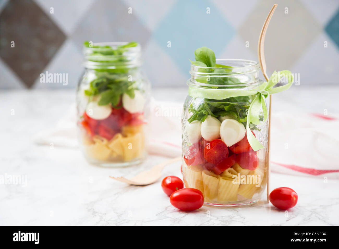 Calabrese salad with pasta, tomatoes, mozzarella, rocket and basil in ...