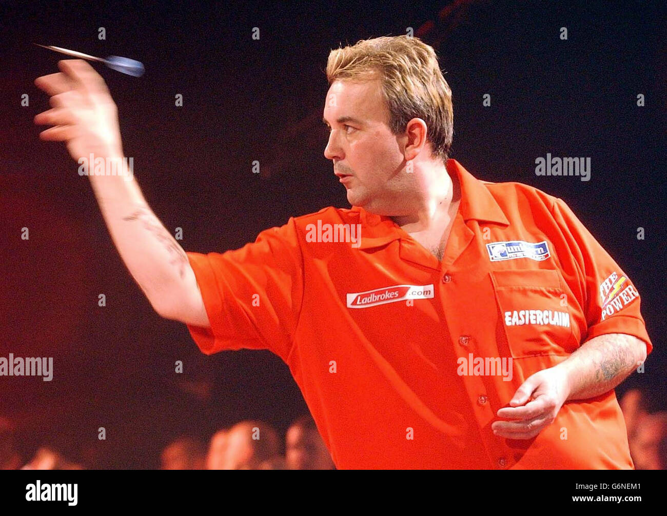 Phil Taylor takes a throw before the start of his semi-final match ...