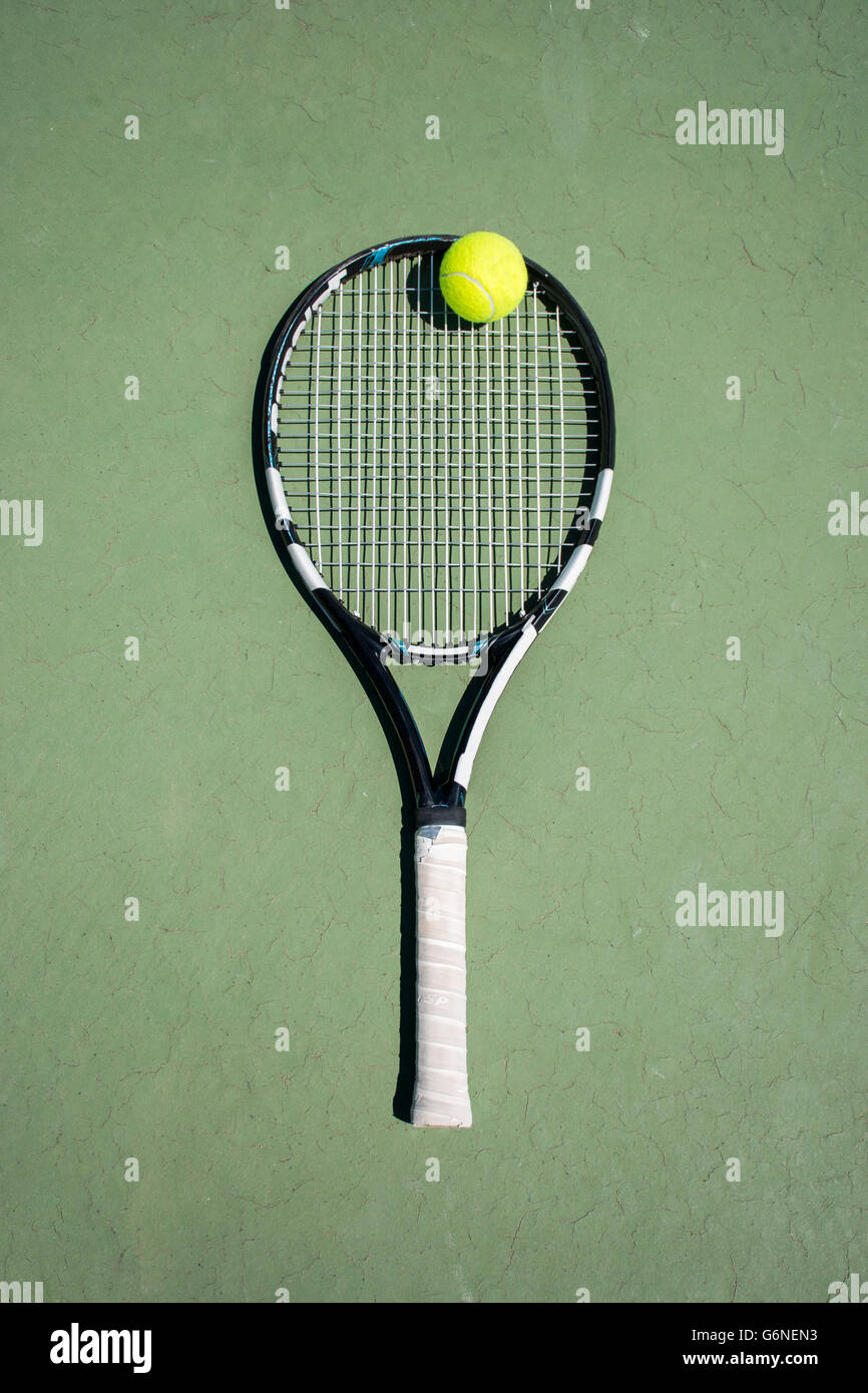 Racket and ball on a tennis court Stock Photo - Alamy