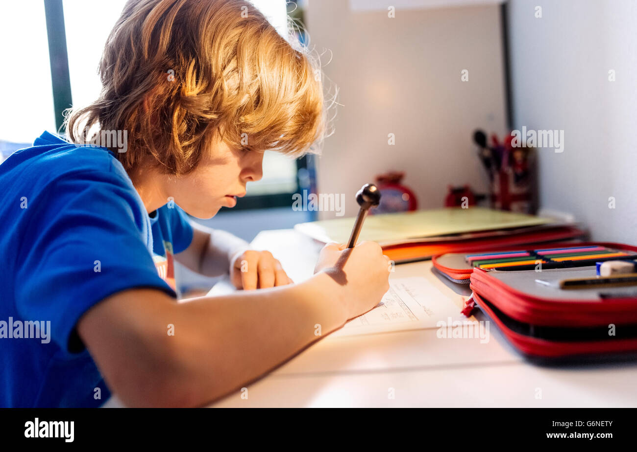 Boy doing homework Stock Photo - Alamy