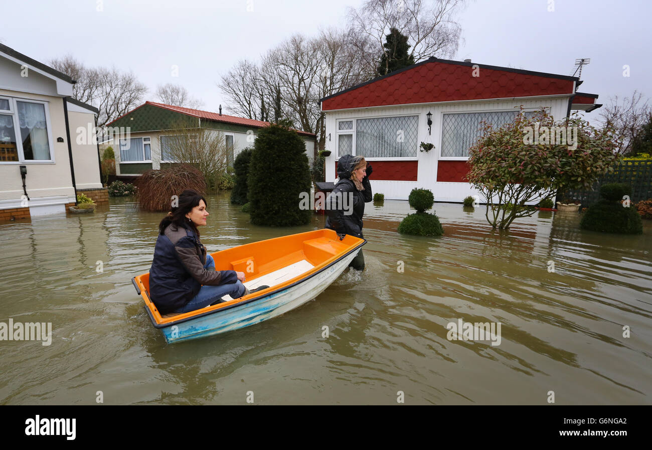 Carole Kuke wades through flood waters to her home at Abbey Fields ...