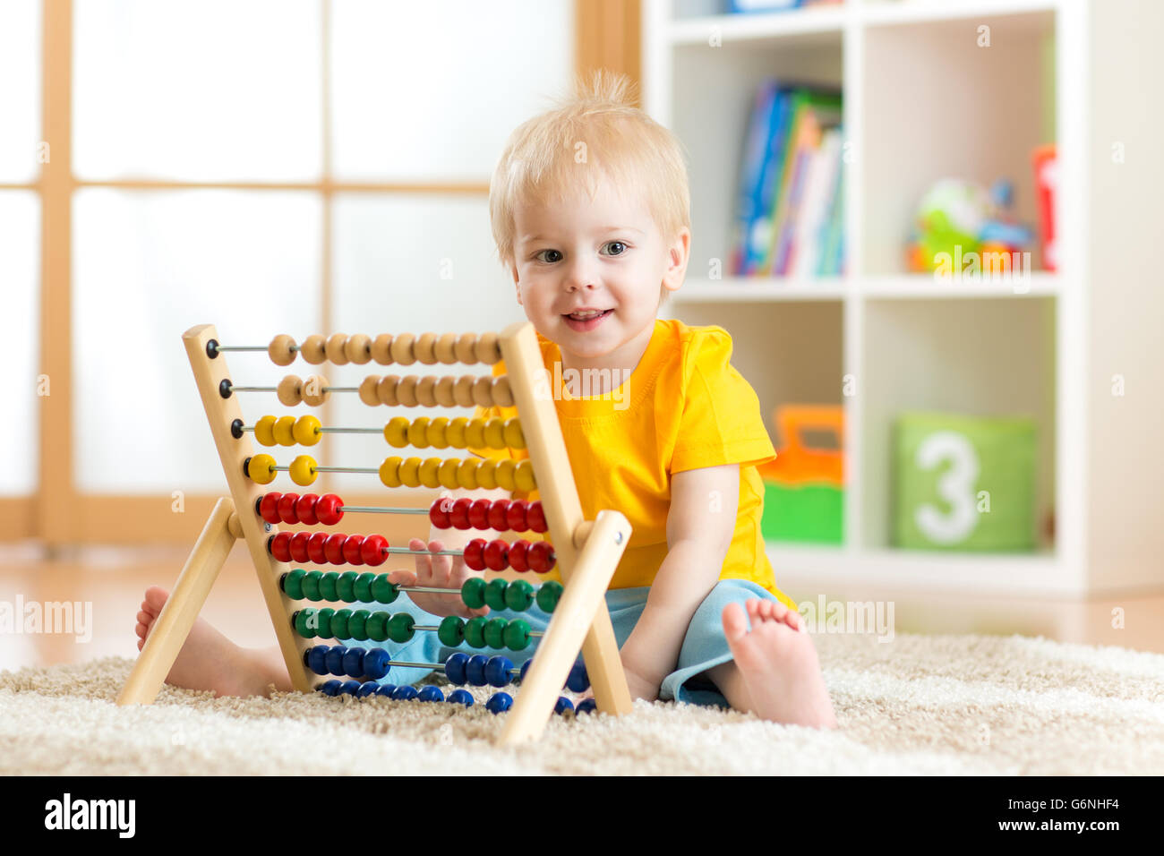 child boy playing with counter toy at home Stock Photo - Alamy