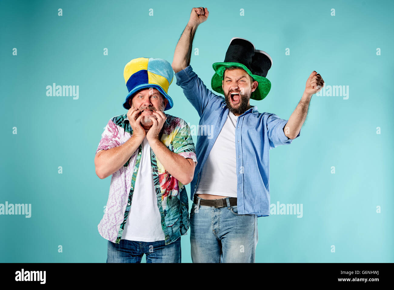 The two football fans over blue Stock Photo - Alamy