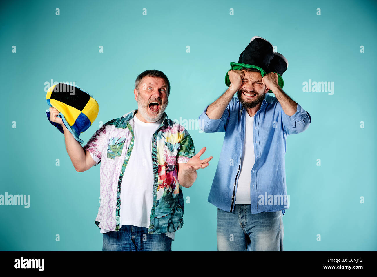 The two football fans over blue Stock Photo - Alamy