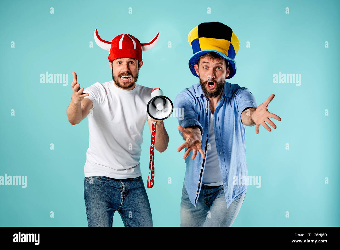 The two football fans with mouthpiece over blue Stock Photo - Alamy
