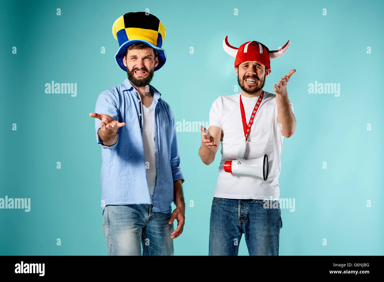 The two football fans with mouthpiece over blue Stock Photo - Alamy