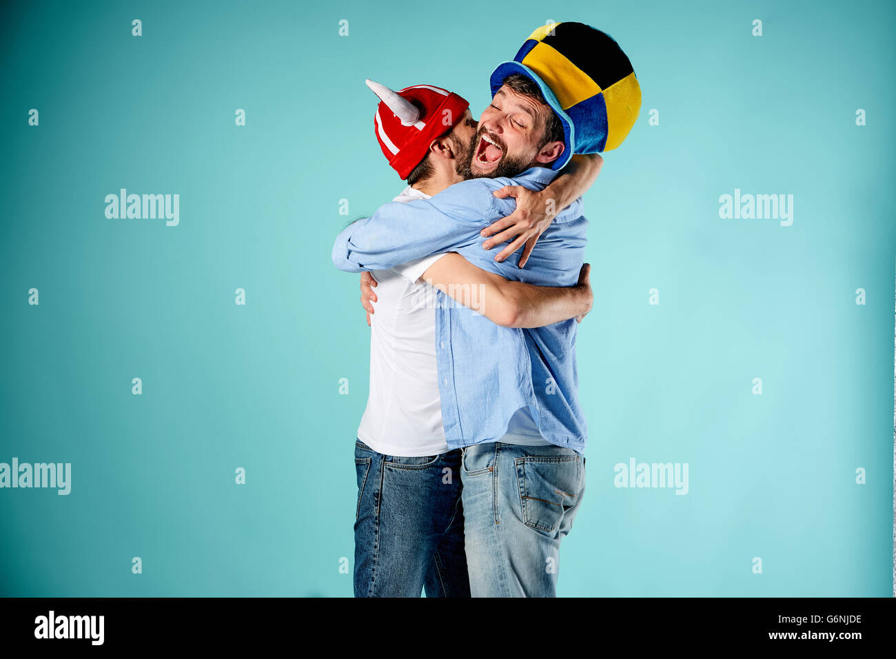 The two football fans over blue Stock Photo - Alamy