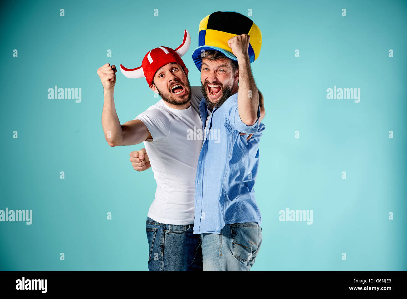 The two football fans over blue Stock Photo - Alamy