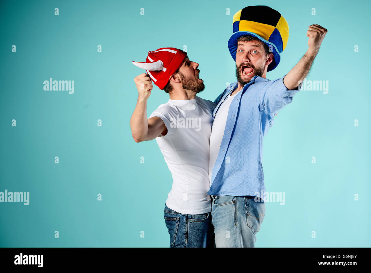 The two football fans over blue Stock Photo - Alamy
