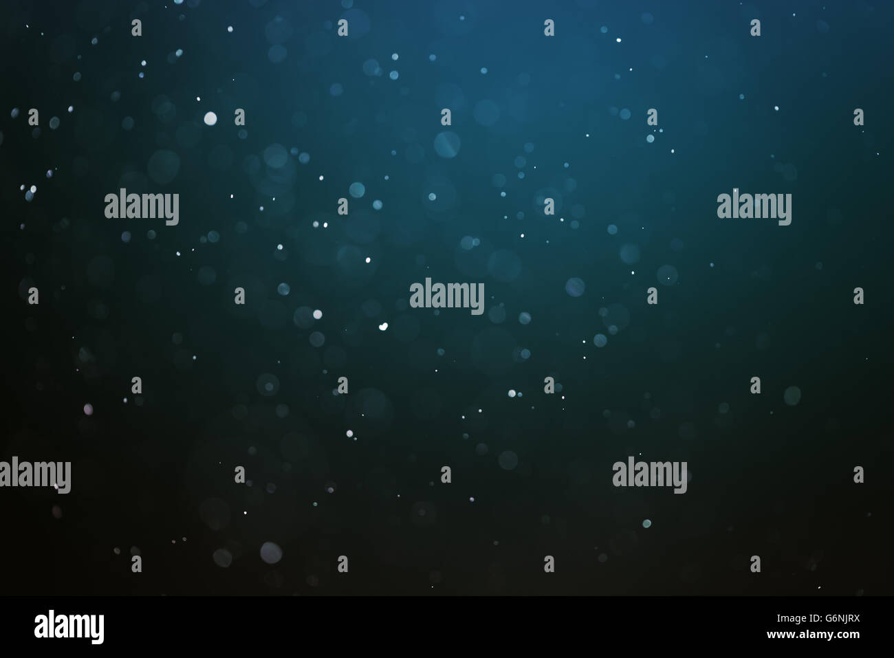 real backlit dust particles with teal toned flare Stock Photo - Alamy