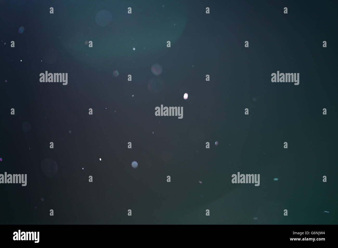 real backlit dust particles with teal toned flare Stock Photo - Alamy