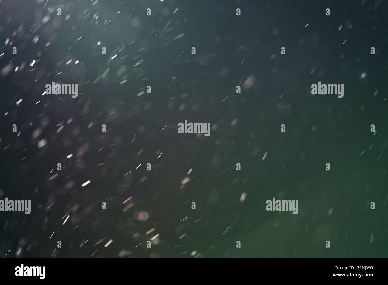 real backlit dust particles with green toned flare Stock Photo - Alamy