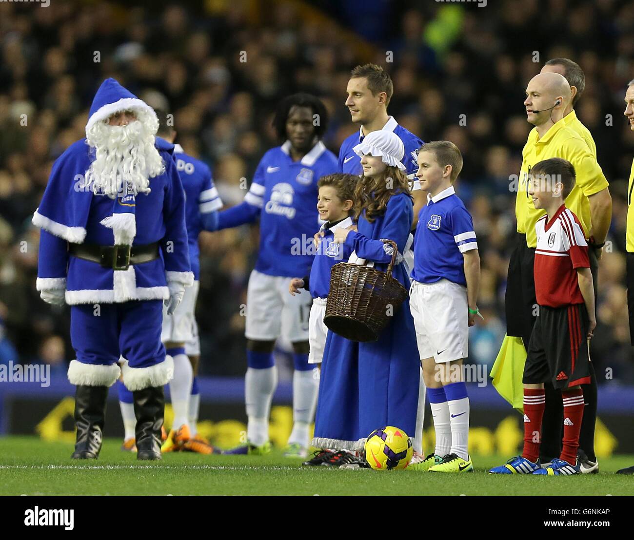Everton captain Phil Jagielka lines up with Santa, the Toffee Lady and ...