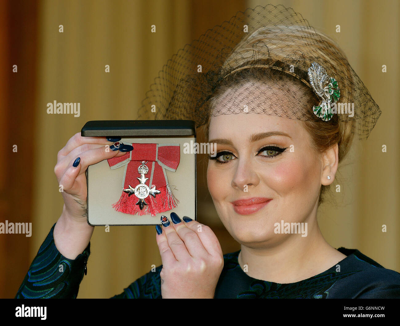 Adele Adkins holding her MBE for services to music presented to her by ...