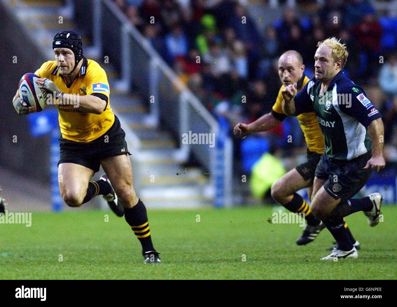 Wasps' Richard Birkett (left) is chased by London Irish's Mark ...
