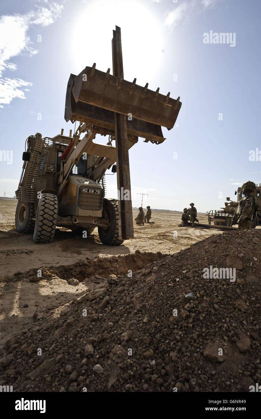 An Army digger places a huge metal post in a hole where British Royal ...