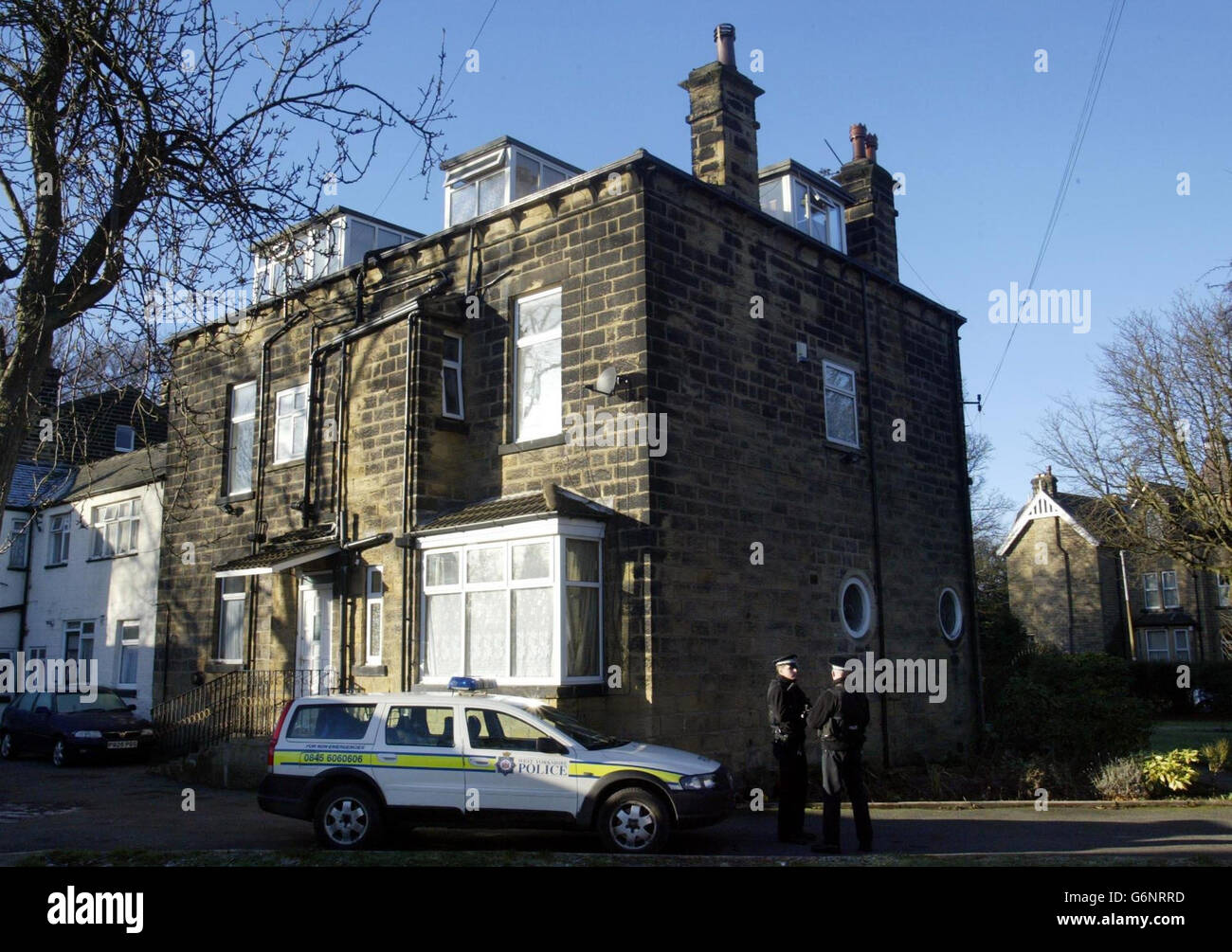 Police stand outside a property on Springwood Grove, Leeds, following ...