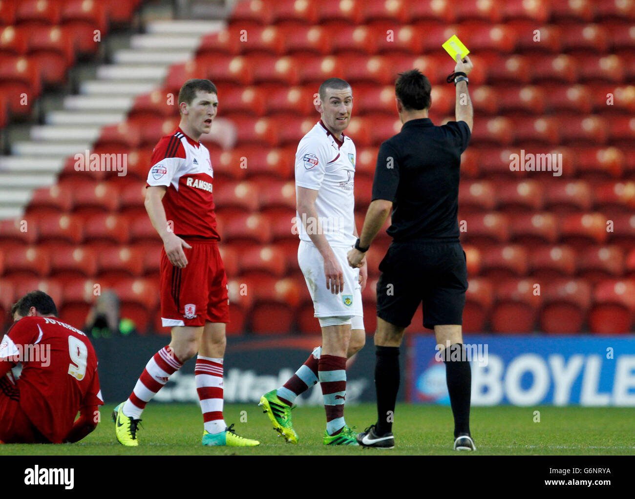 Burnley's David Jones is booked by referee Mark Clattenburg Stock Photo ...