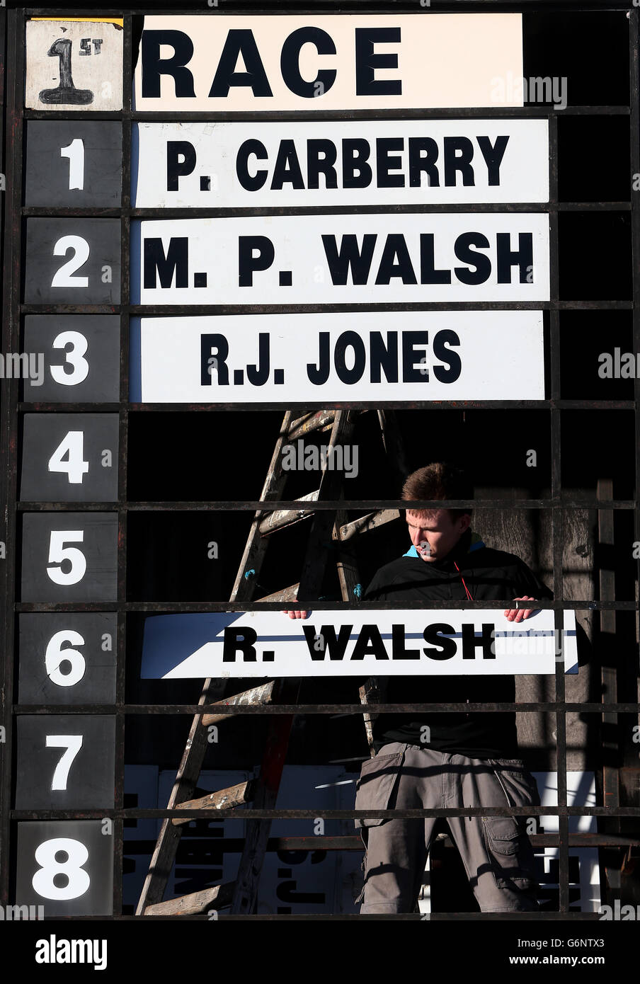 Craig Byrne prepares the results board ahead of the first race during ...