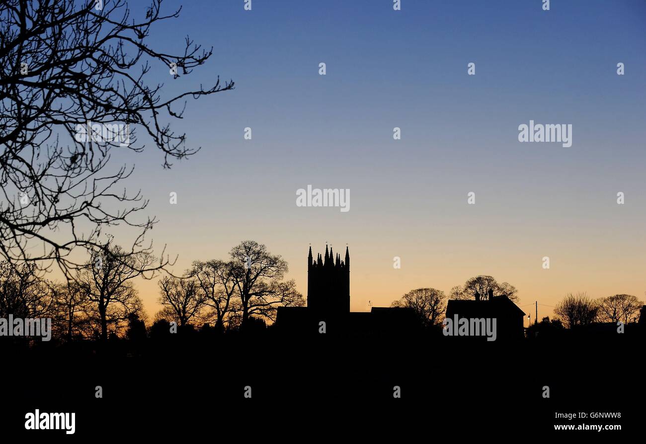 The sun begins to rise behind the Church of St Mary the Virgin in ...