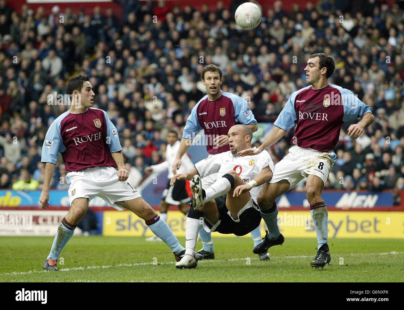 Manchester United's Mikael Silvestre is crowded out by Aston Villa's ...