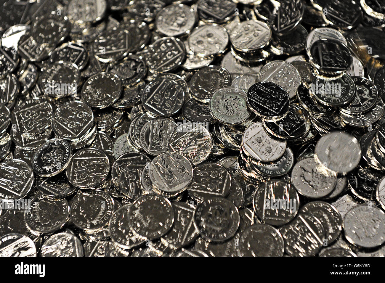 Shiny new 10p pieces come off the production line at the Royal Mint in ...