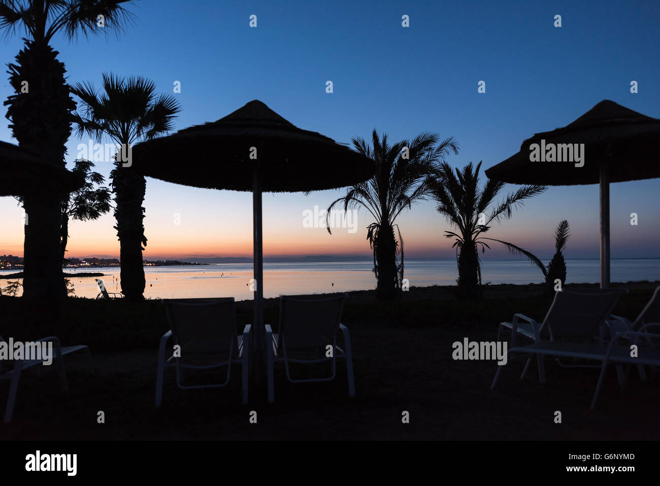 Photo of beach and sea in protaras, cyprus island with beach chairs and ...