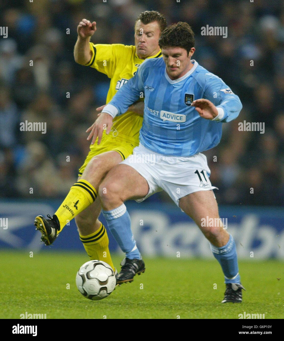 Manchester City's John Macken (right) challenges Graham Stewart of ...