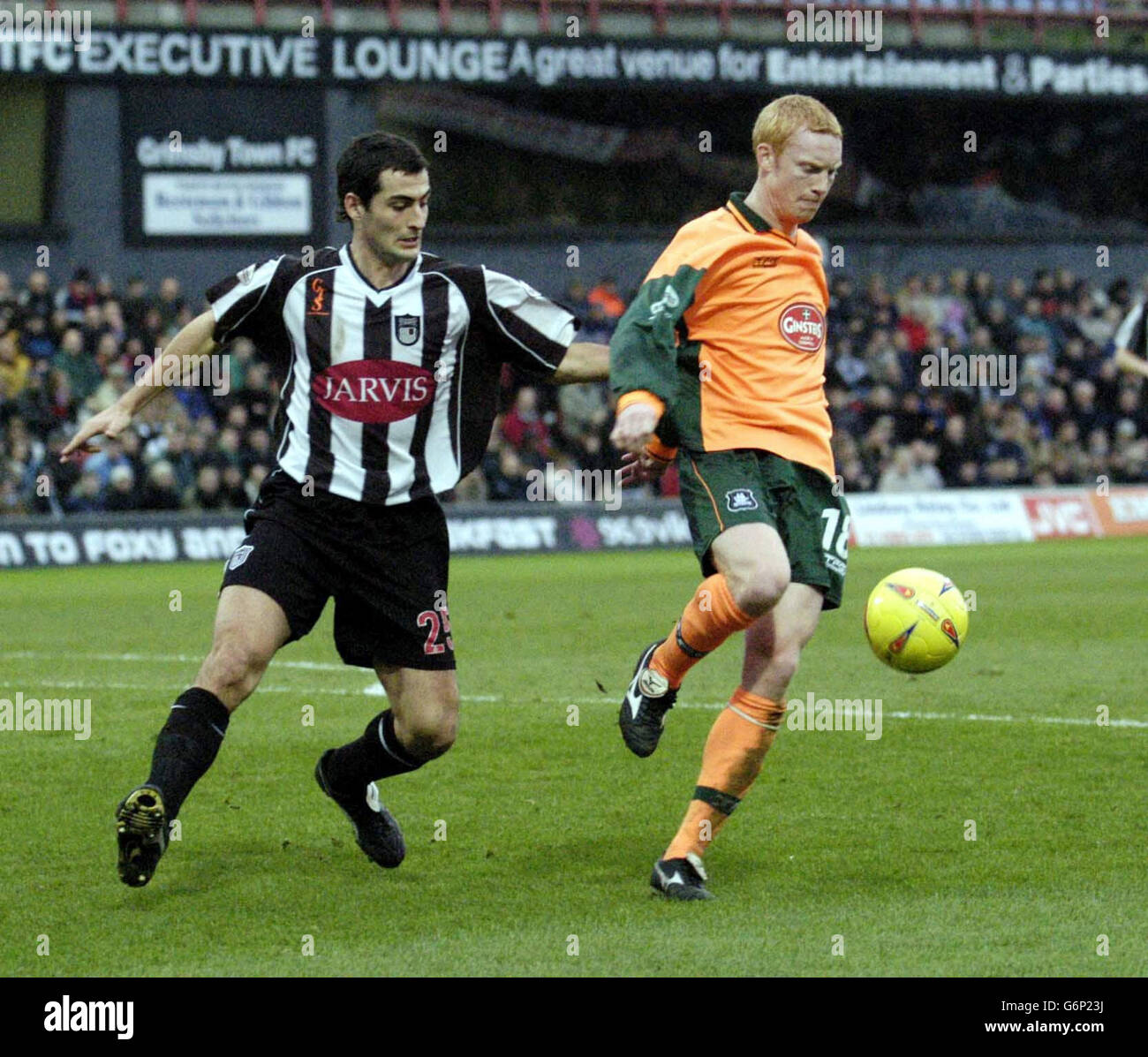 Grimsby's Mike Edwards (left) puts pressure on Nathan Lowndes of ...