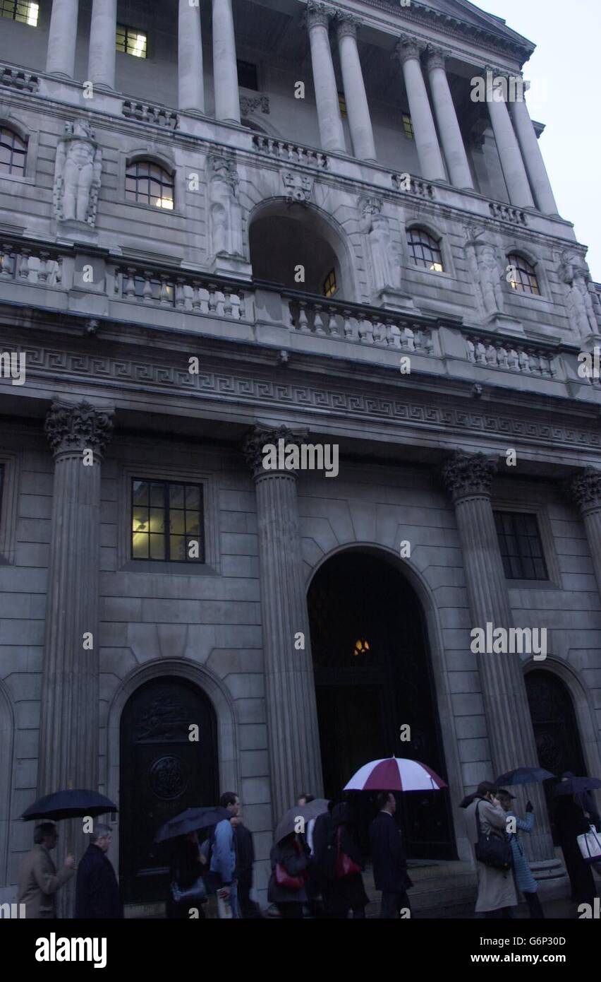 Workers bustle along past the Bank of England in the city of London ...