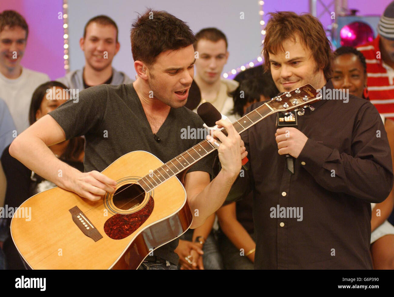 Host Dave Berry (L) learns how to rock from actor Jack Black during his ...