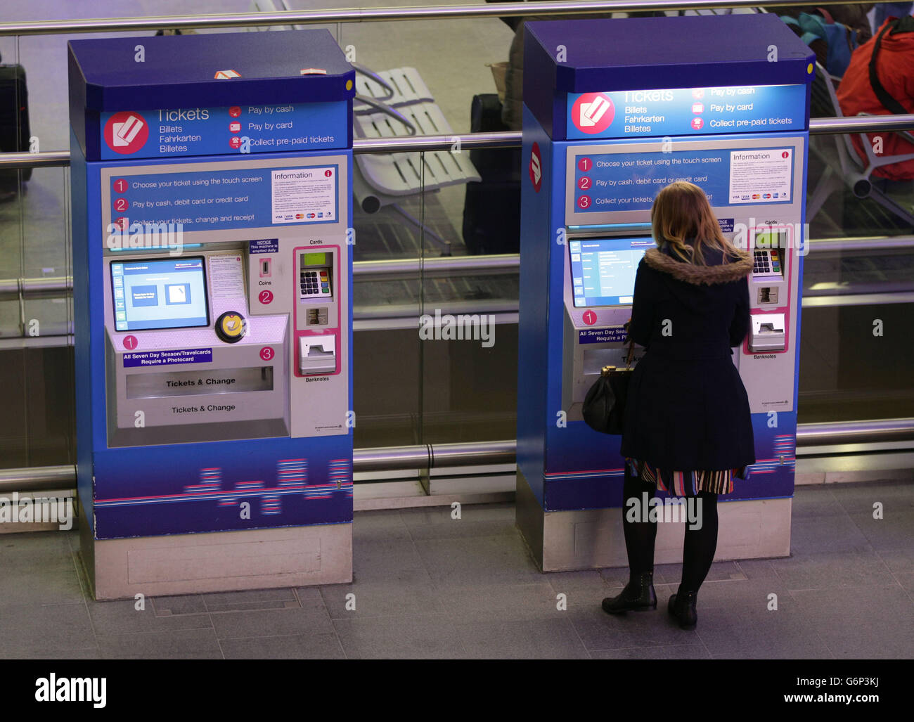 A commuter using a ticket machine at Kings Cross Station, in London, on ...