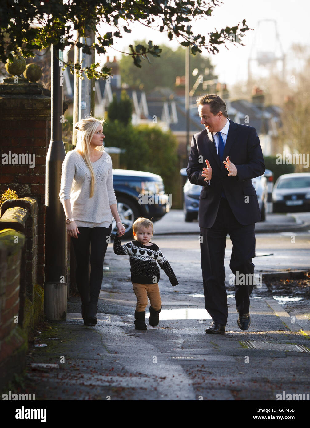Prime Minister David Cameron walks with Sharon Ray and her daughter ...