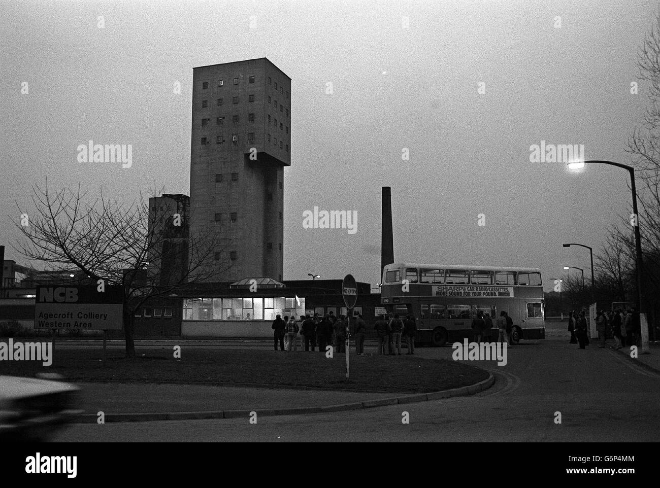 A bus carrying morning shift miners drives passeda small group of NUM ...