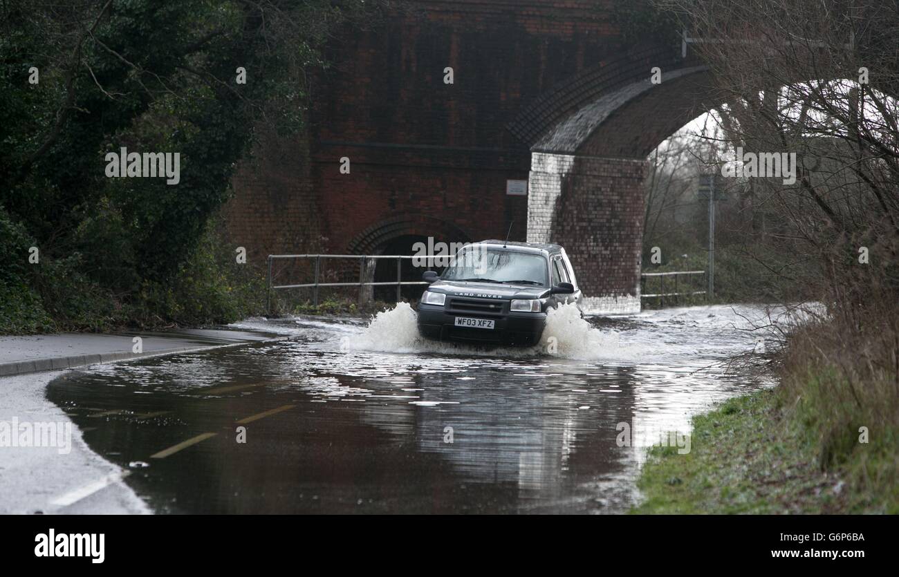 A car moves through floodwater in Burton, Dorset as the Environment ...