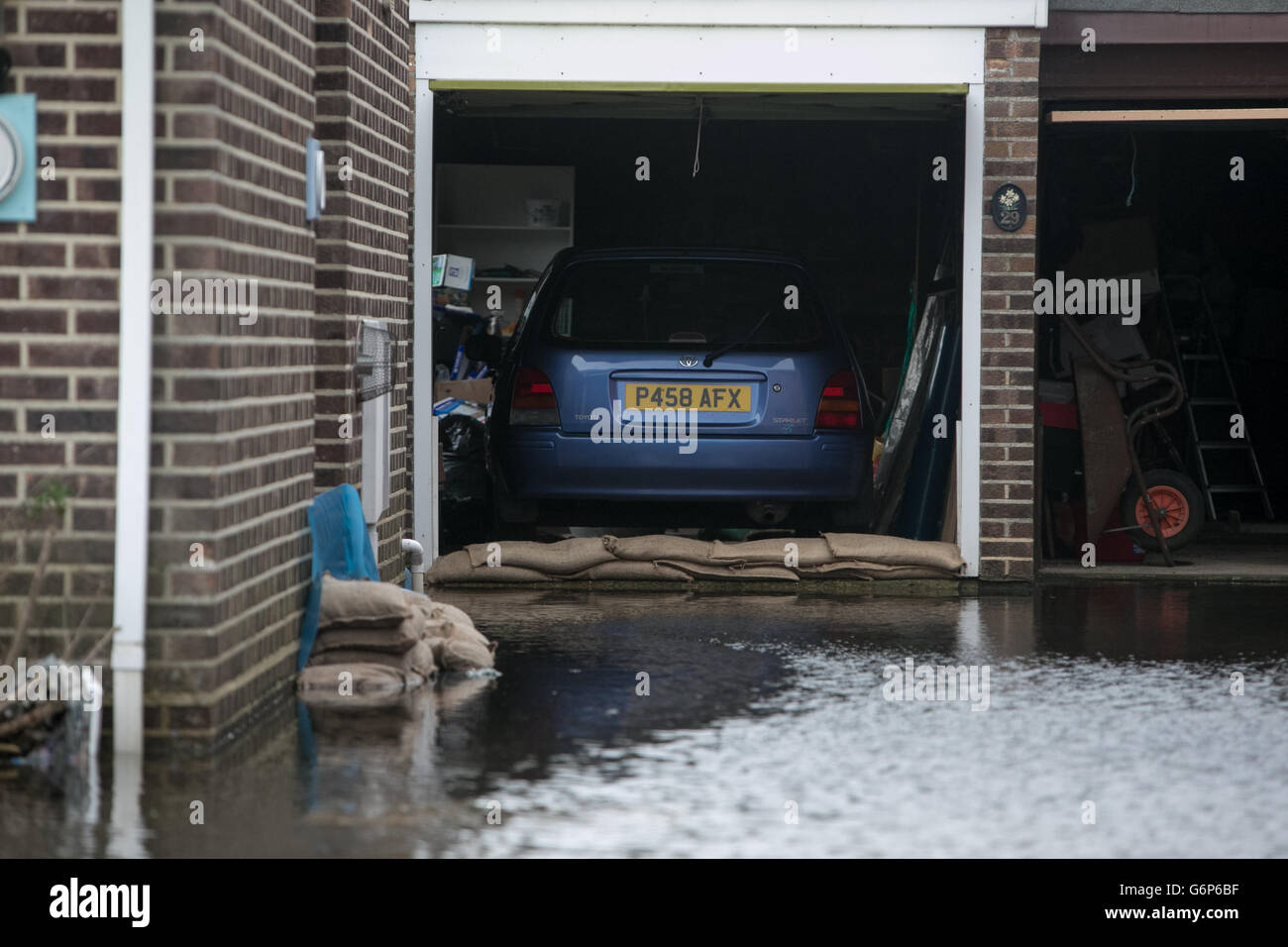 Flooded homes in Burton, Dorset as the Environment Agency has warned ...