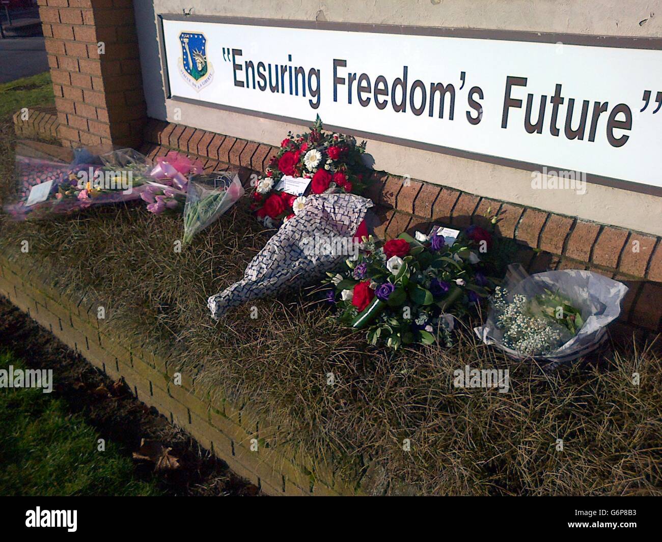 Floral tributes are left outside the front gate of RAF Lakenheath, as ...