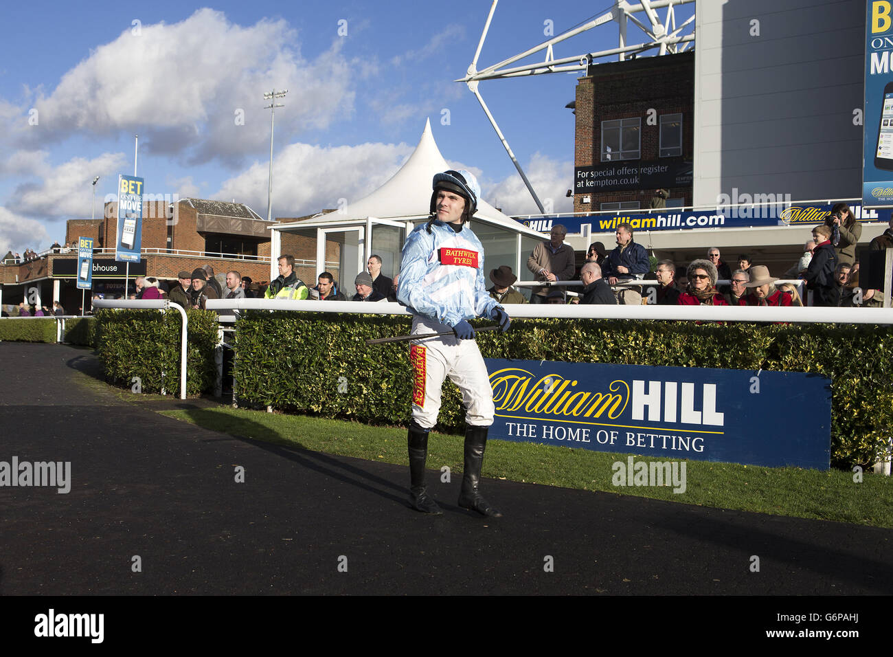 Jockey Tom Scudamore walks from the clubhouse to the parade ring prior ...