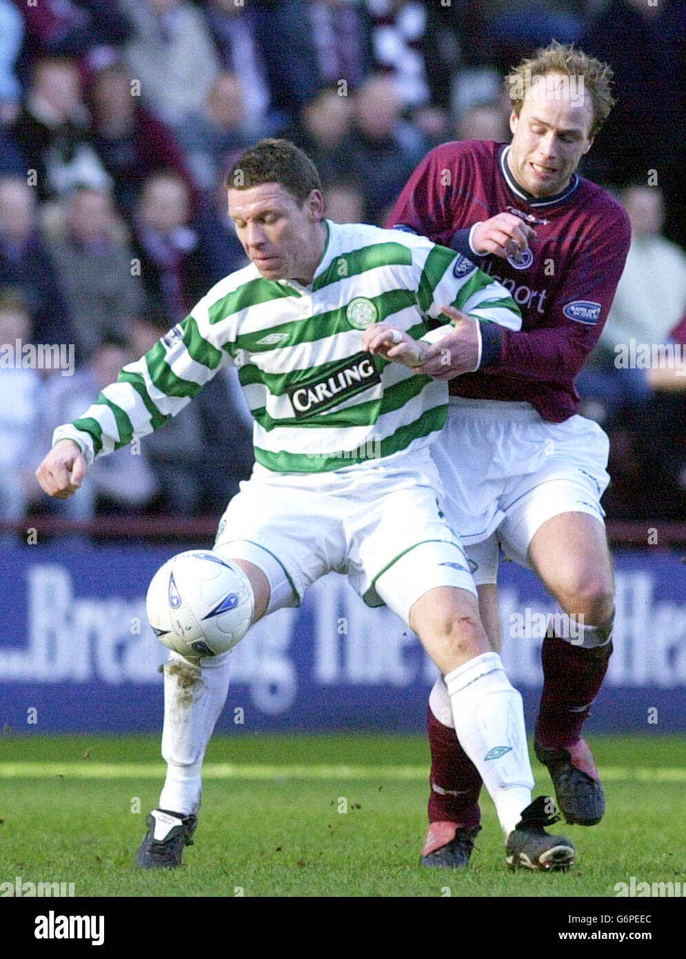 Celtic's Alan Thompson (L) shields the ball from Hearts' Neil ...