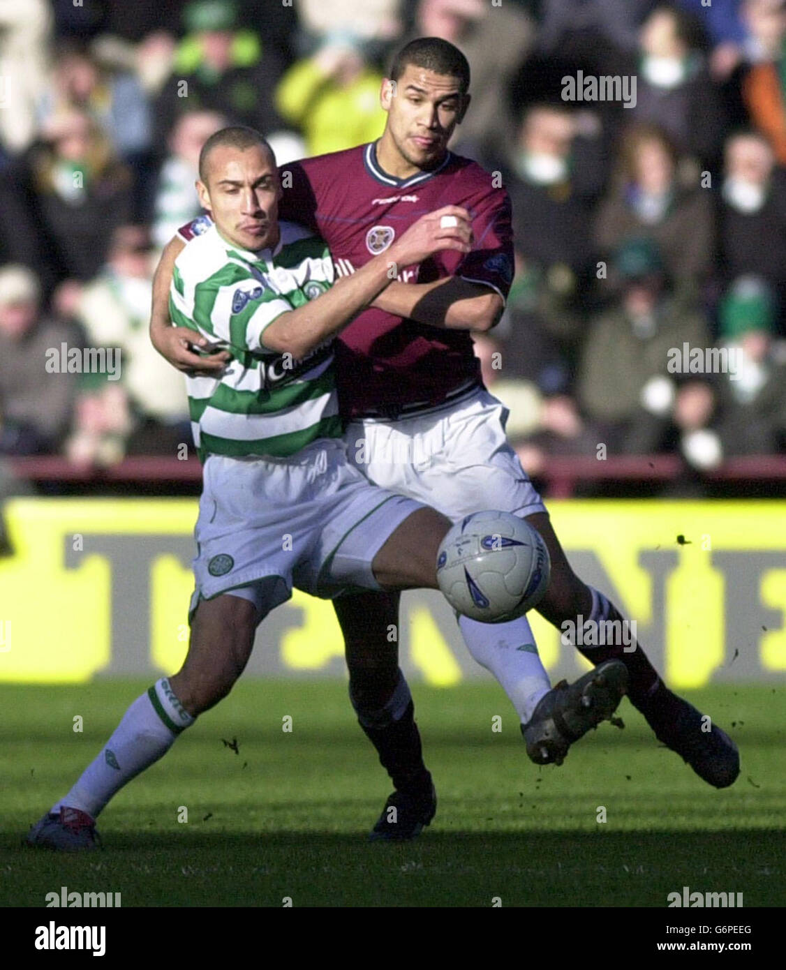 Celtic's Henrik Larsson (L) challenges Hearts' Patrick Kisnorbo during ...