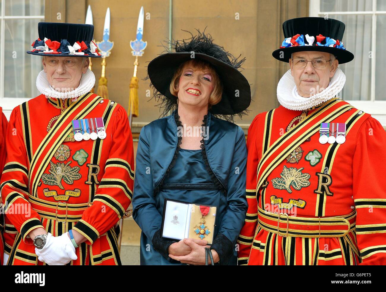 Artist Grayson Perry (centre) holds his CBE presented to him by the ...
