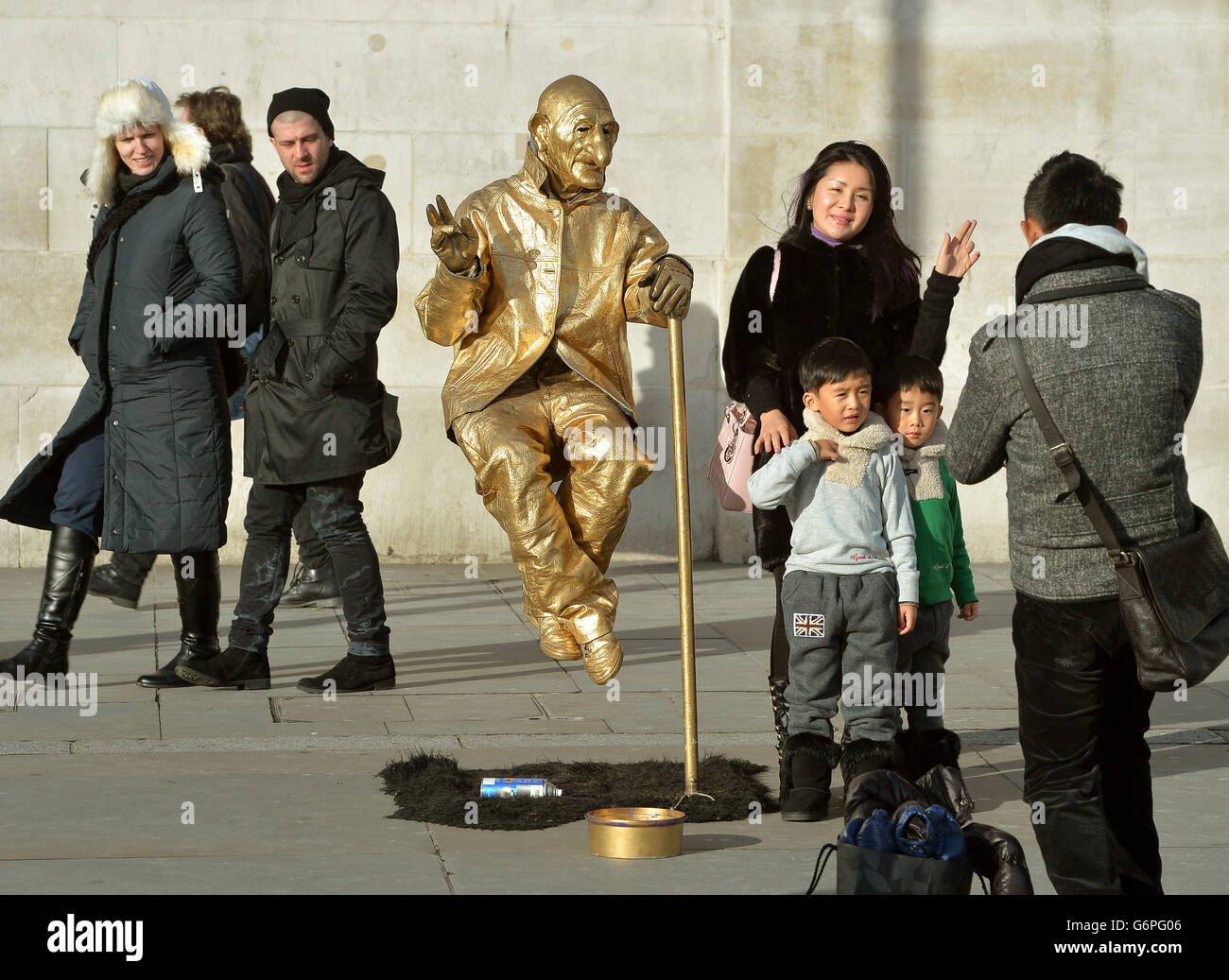 A human street Statue entertains tourists outside the National Gallery ...