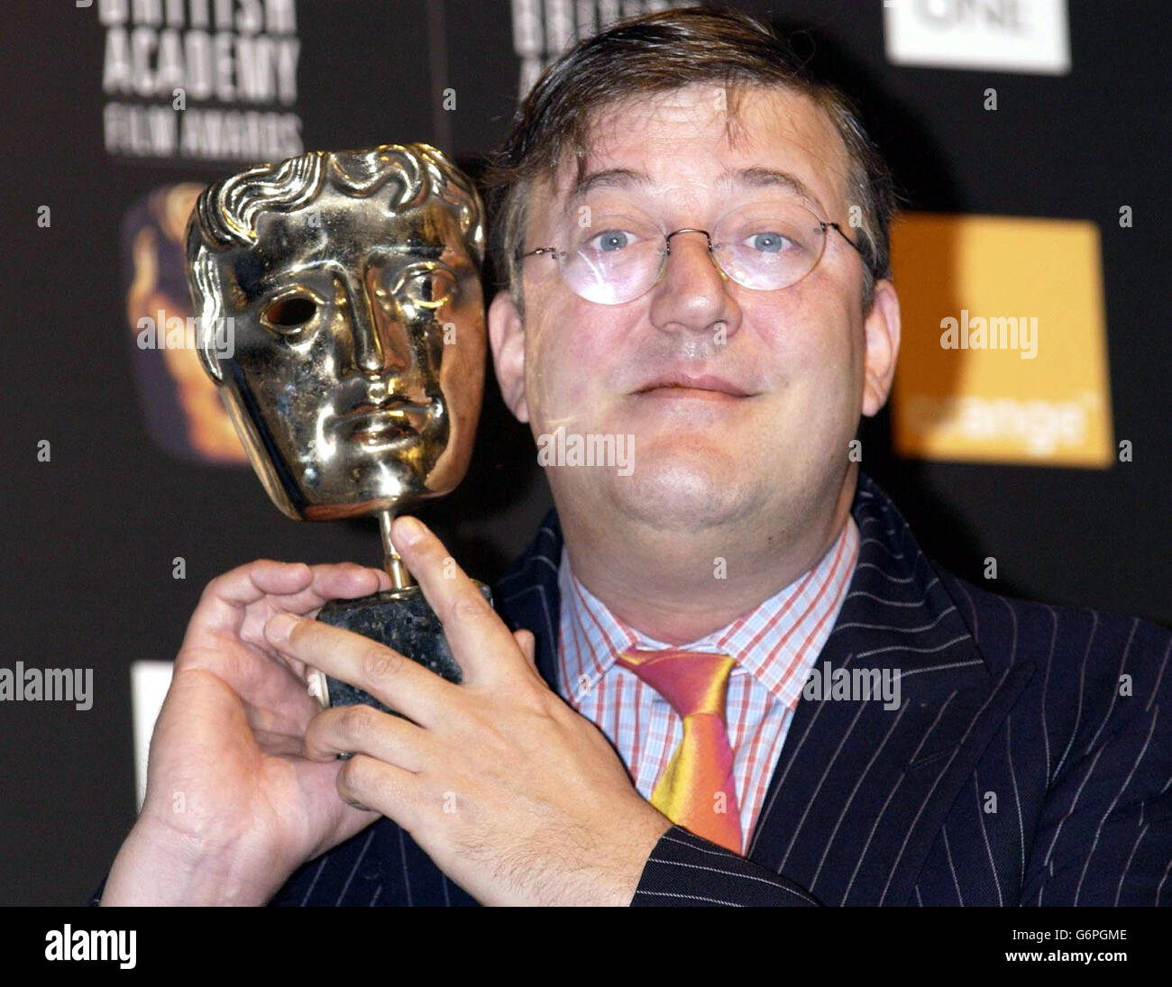 Actor, comedian and writer Stephen Fry holds a BAFTA Award during a ...