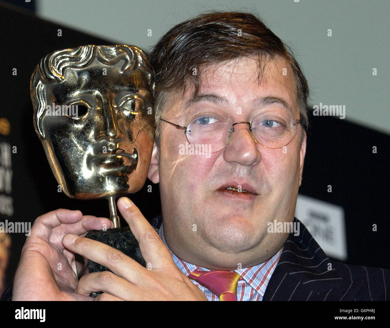 Actor, comedian and writer Stephen Fry holds a BAFTA Award during a ...